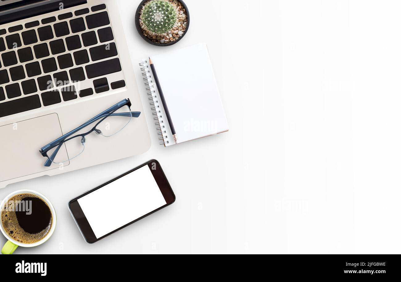 White office desk table with laptop computer, smart phone, notebook and ...