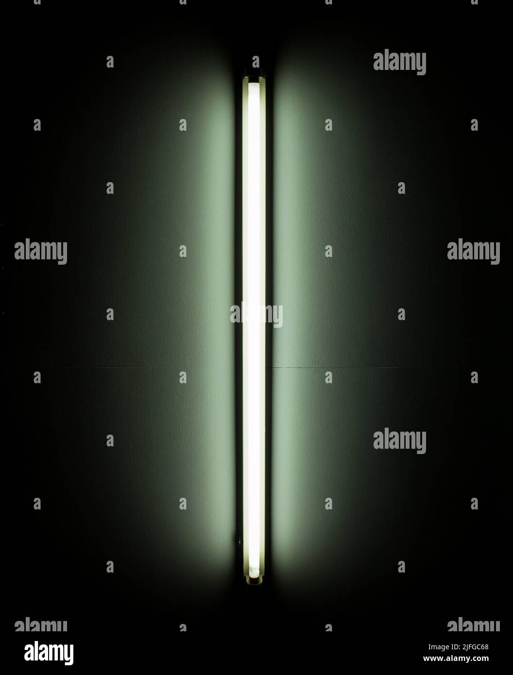 Detail of a fluorescent light tube mounted on a wall Stock Photo - Alamy