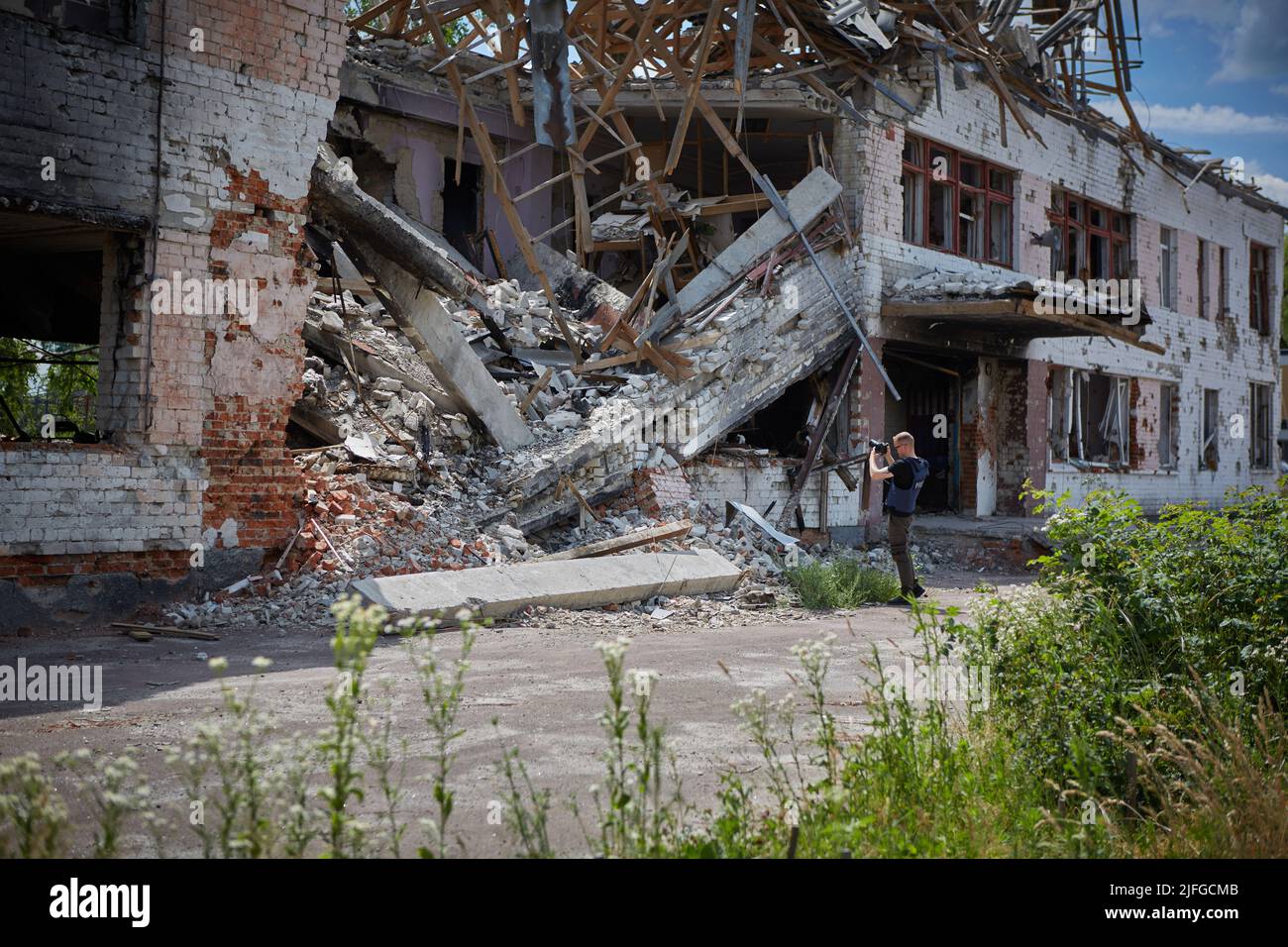 War correspondent photographs destroyed buildings after the bombing ...