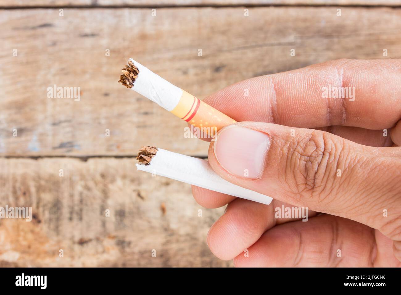 Close up cigarette roll in hand holding Stock Photo - Alamy