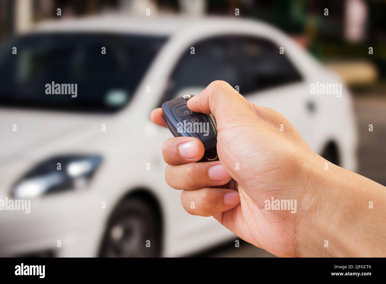 Men's hand presses on the remote control car alarm systems Stock Photo ...
