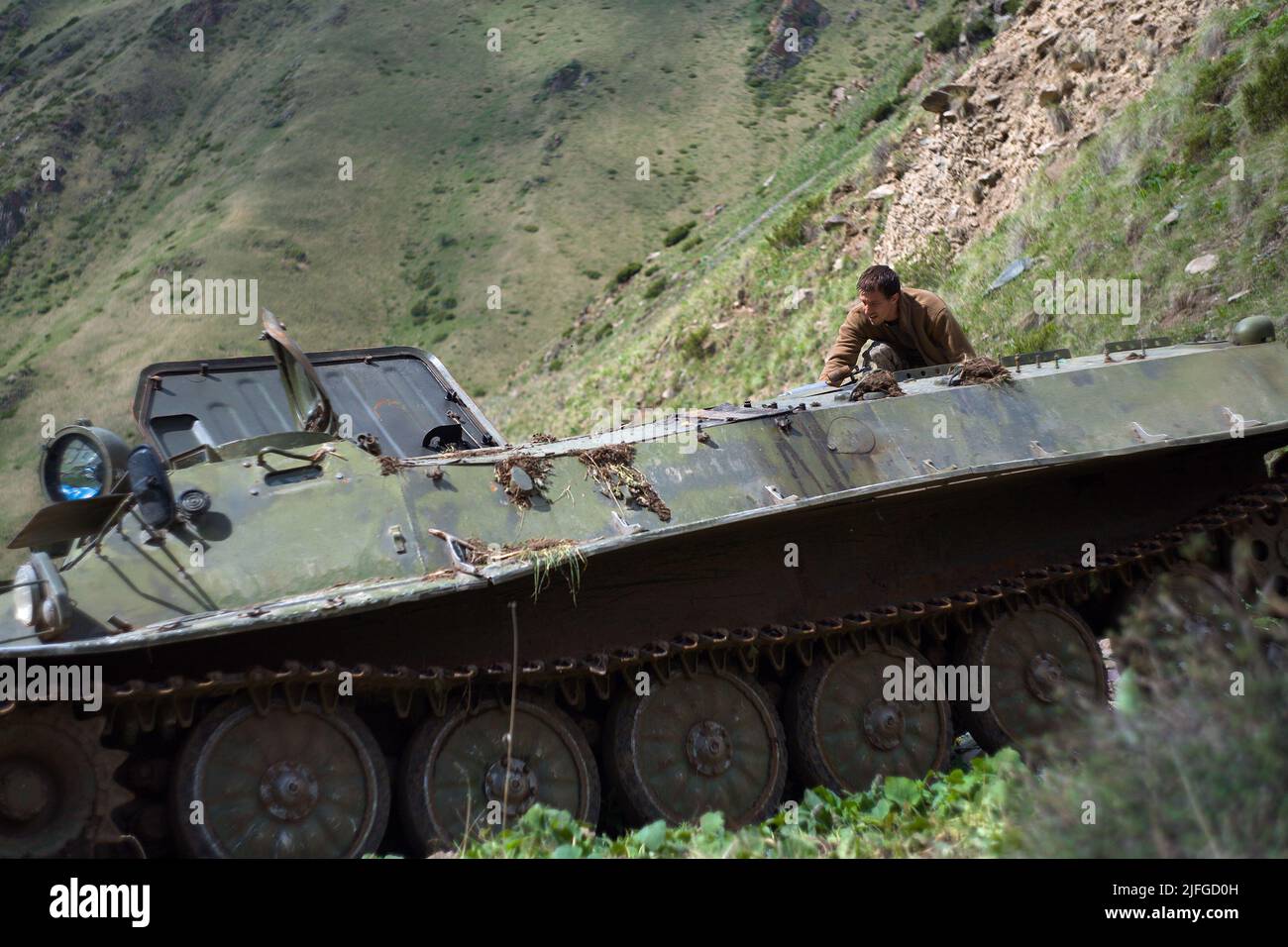 Soldier near the damaged armored personnel carrier Stock Photo - Alamy