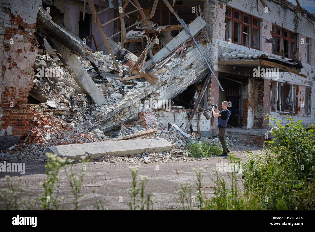 War correspondent photographs destroyed buildings after the bombing ...