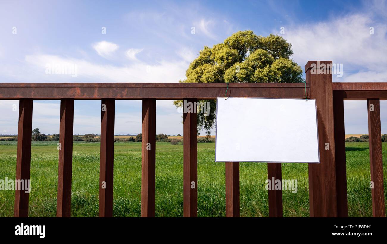 Mockup of sign on fence with oak tree and blue sky background in field ...