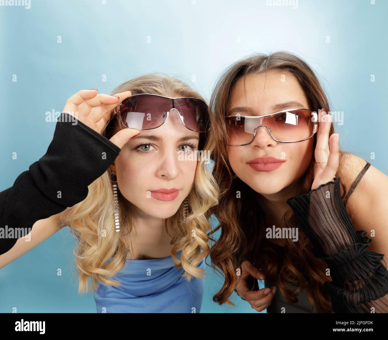 2 young hipster women look curiously directly into the camera | close ...