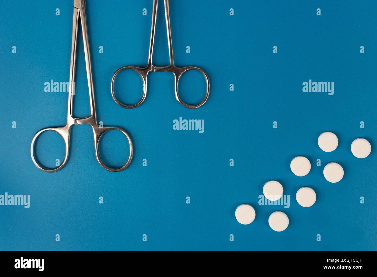 Surgical instrument and medical capsules on a blue background Stock ...