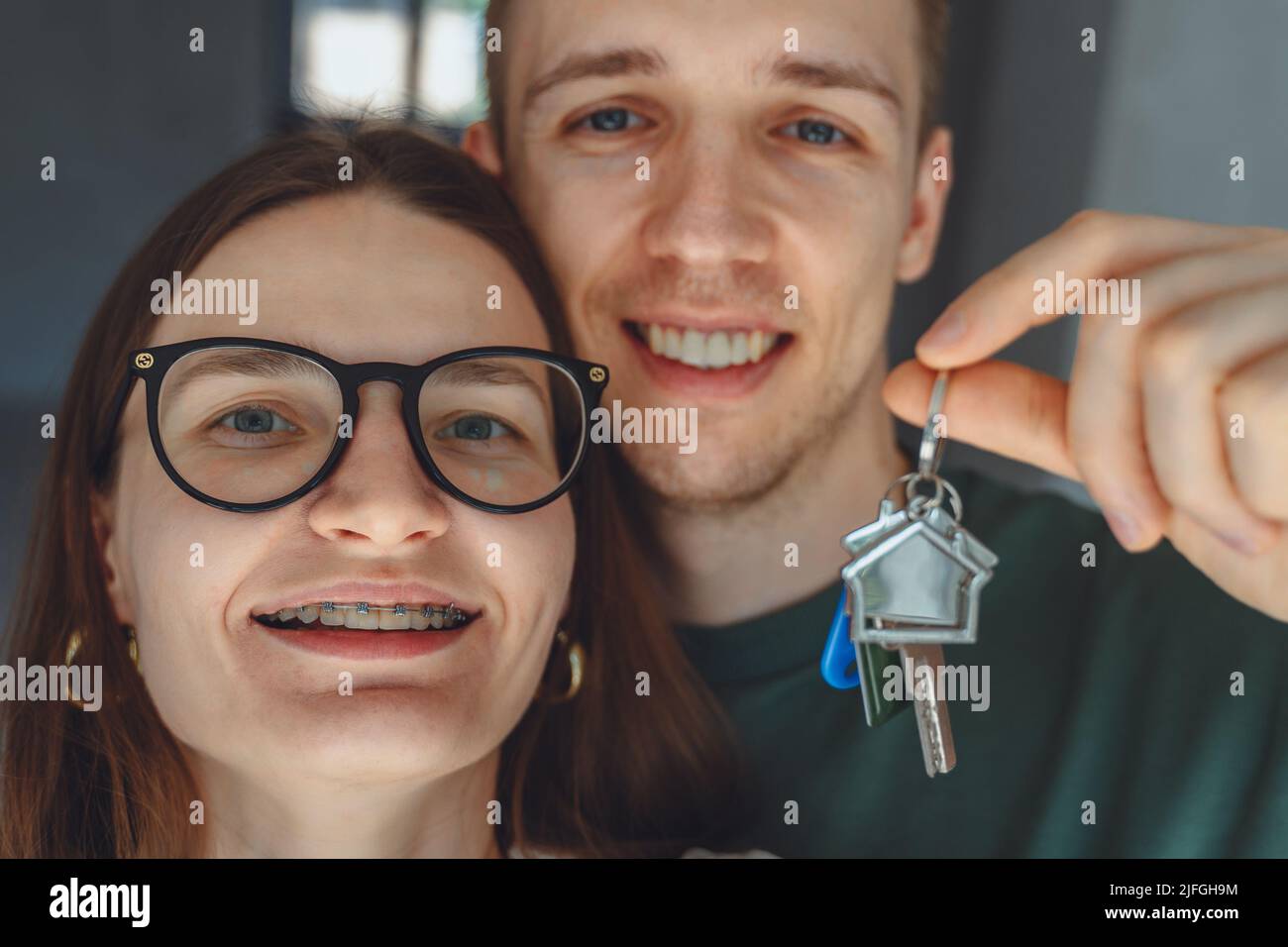 Head shot portrait overjoyed millennial married couple showing keys ...