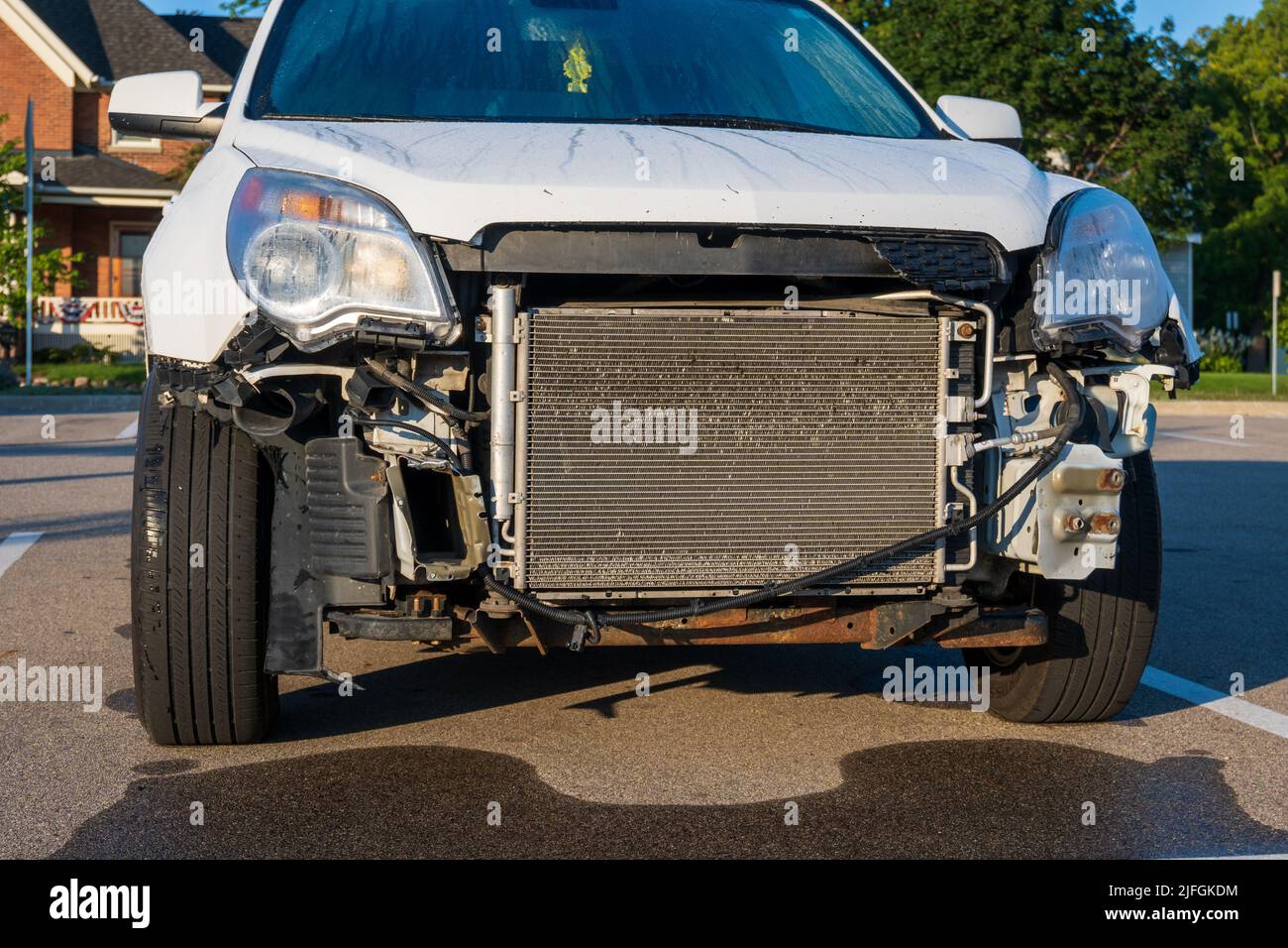 White automobile with front end damage missing bumper and grill Stock ...