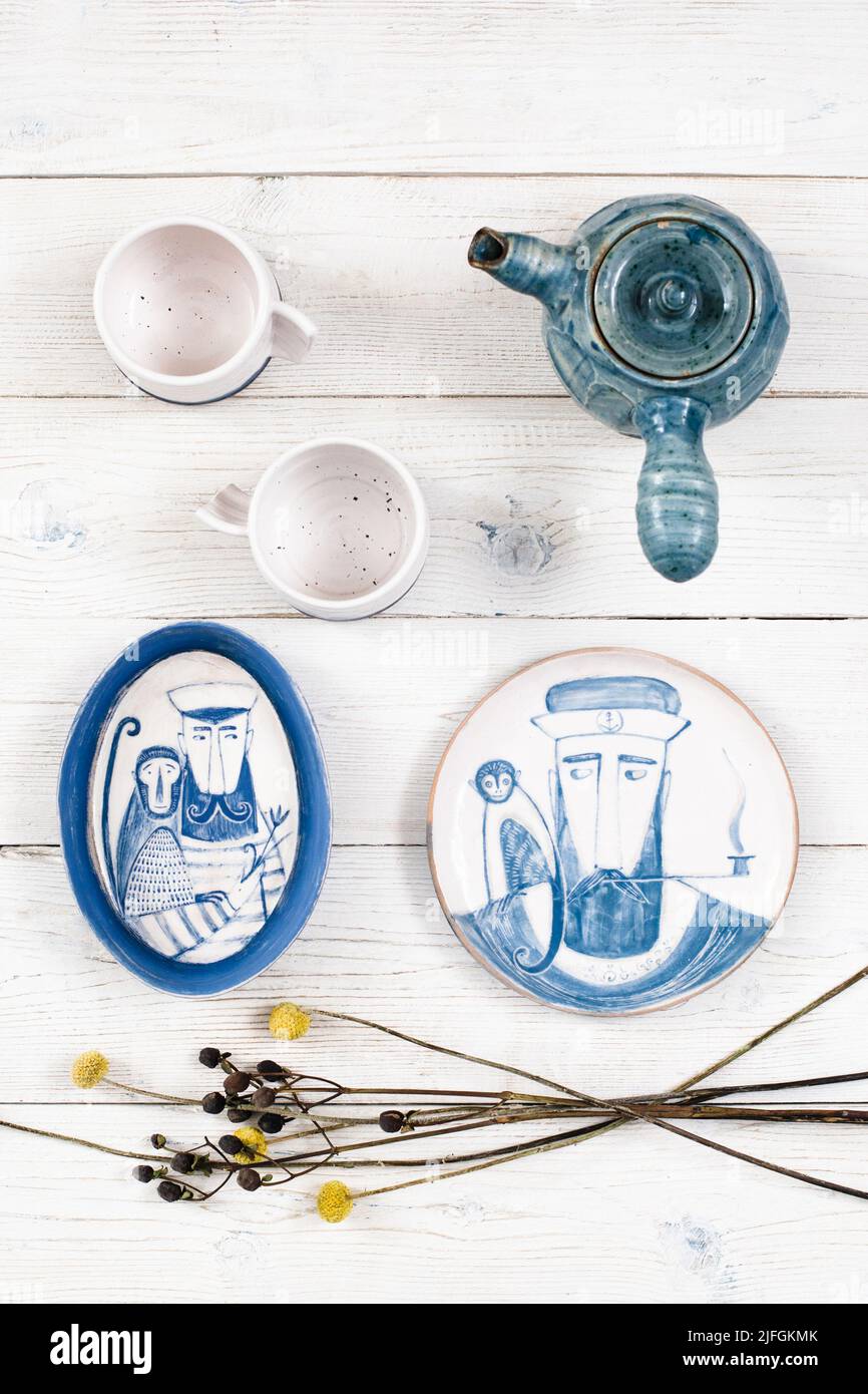 Cups, teapot and painted plates flat lay Stock Photo - Alamy