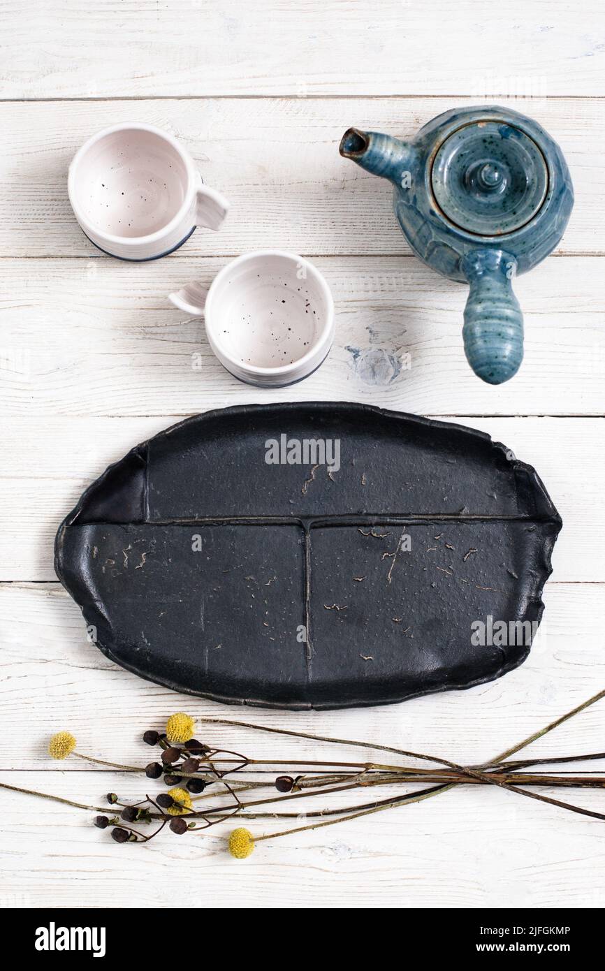 Flat lay of clay tea set composition Stock Photo - Alamy