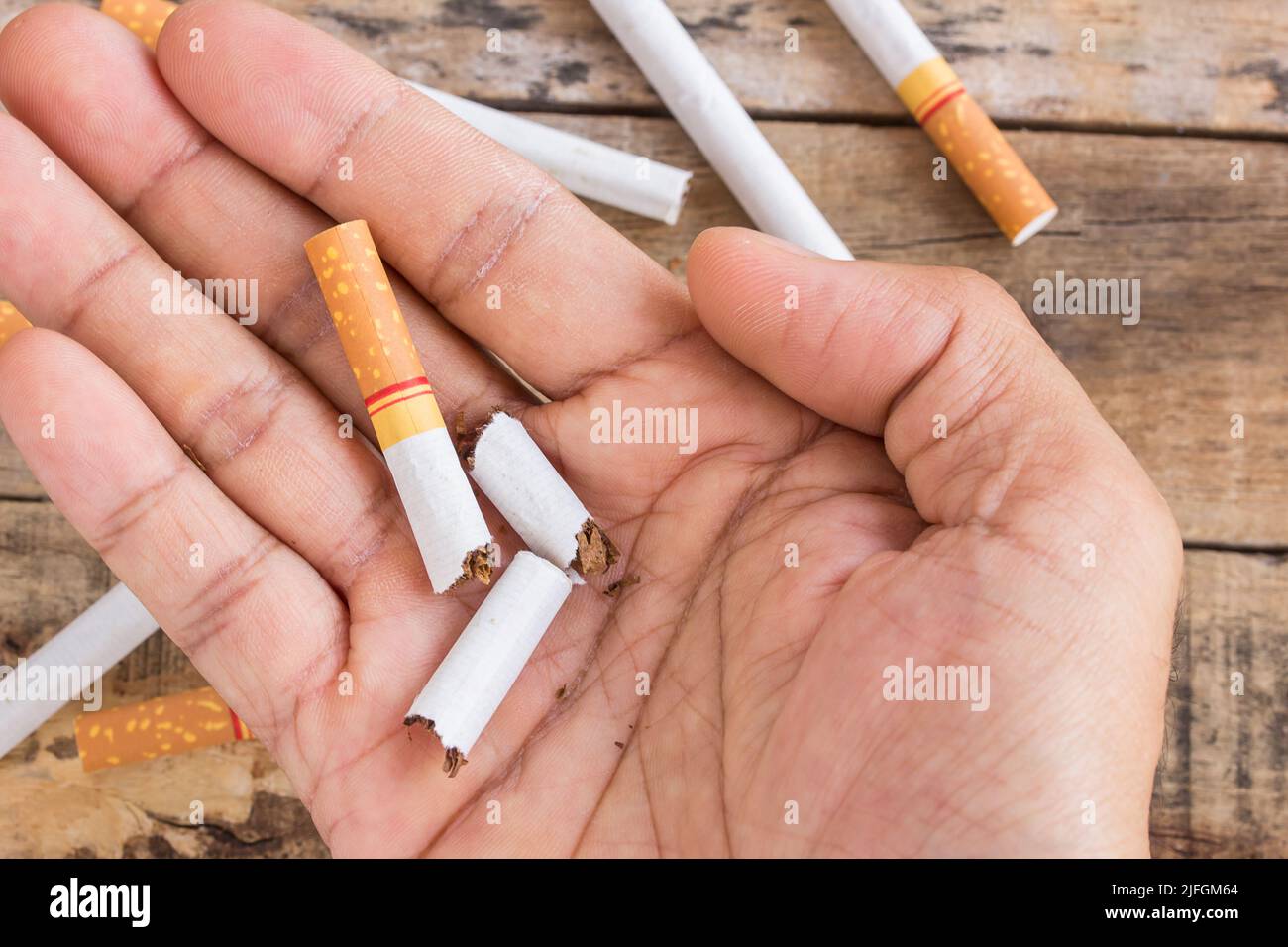 Close up cigarette roll in hand holding Stock Photo - Alamy