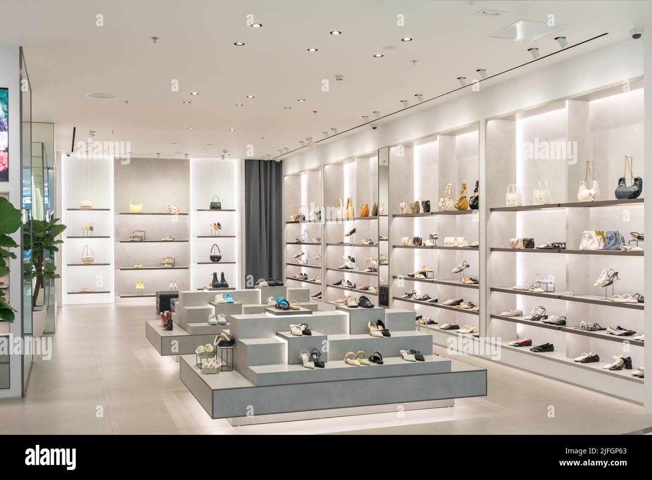 A luxury fashion store with white interior Stock Photo - Alamy