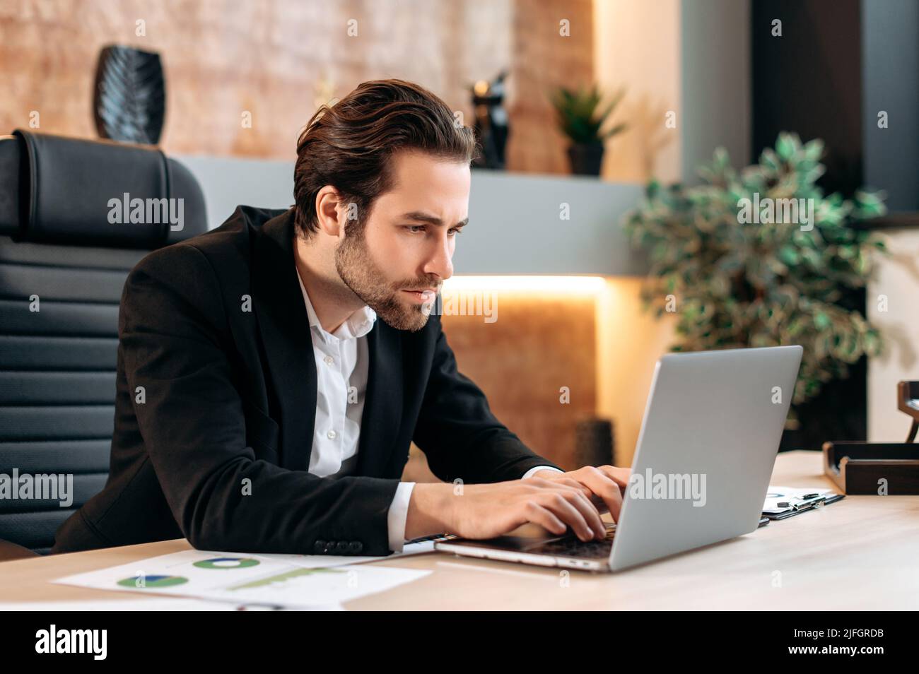 Focused clever caucasian programmer, business man, IT specialist, sits ...