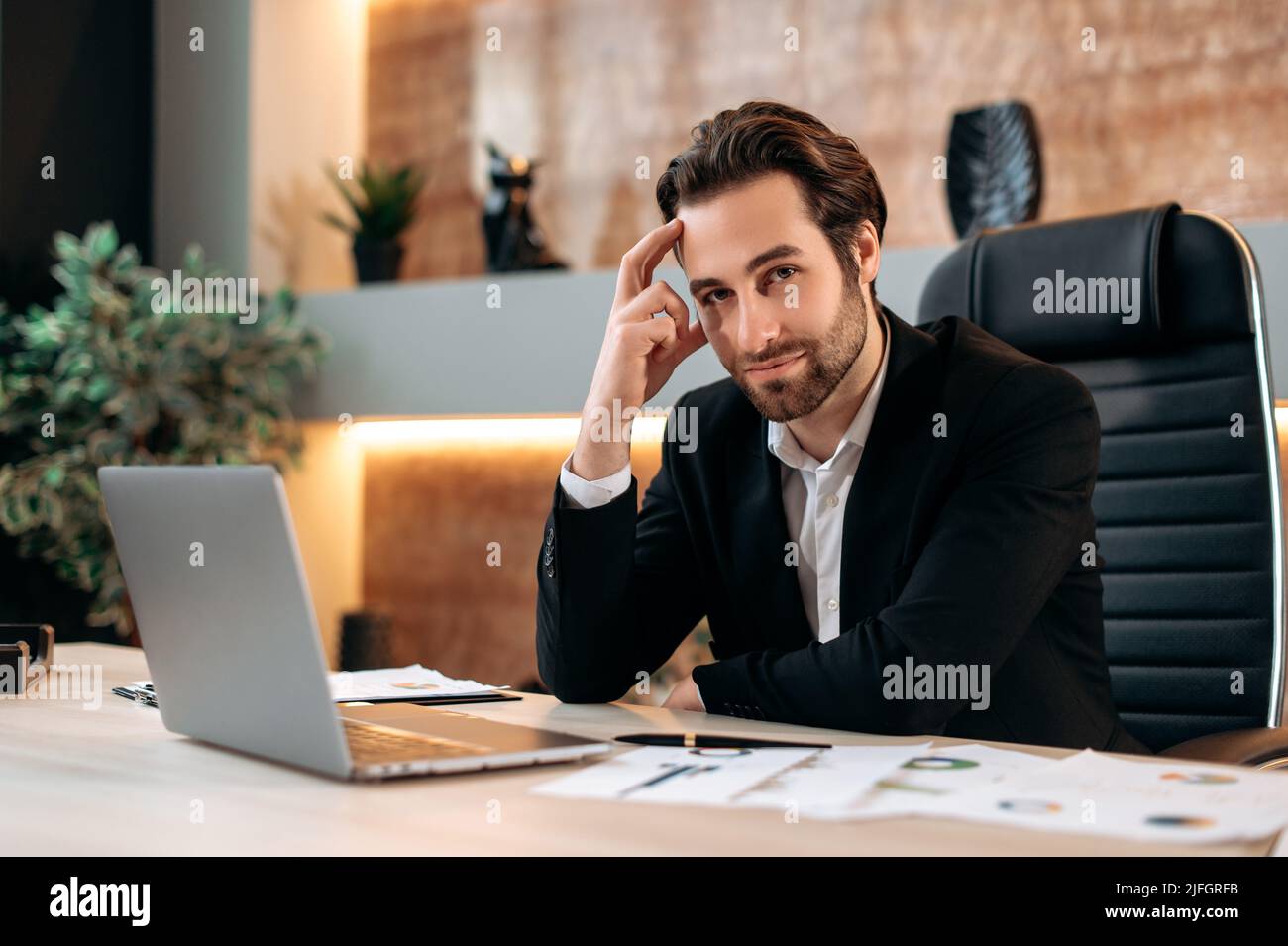 Portrait of a handsome attractive positive caucasian businessman in a ...