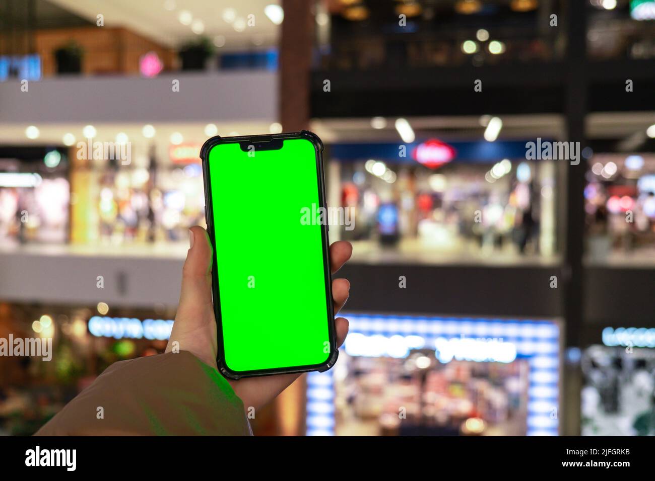 Chroma key. Close up of woman hand holds smart phone vertical with ...
