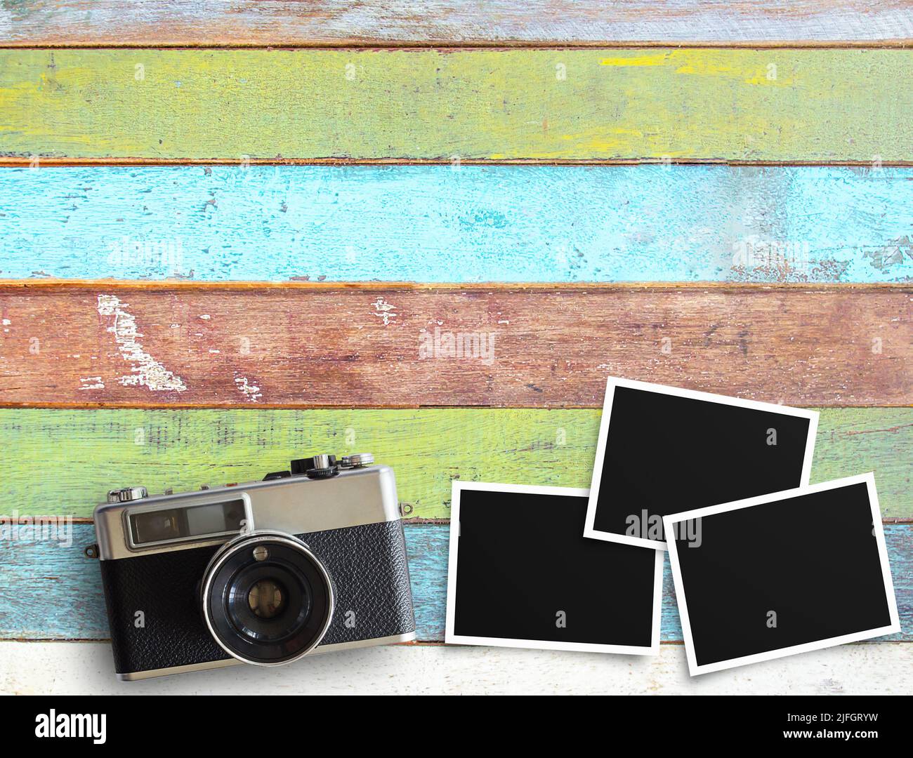 Vintage camera and old blank photo frame on office desk or wooden ...