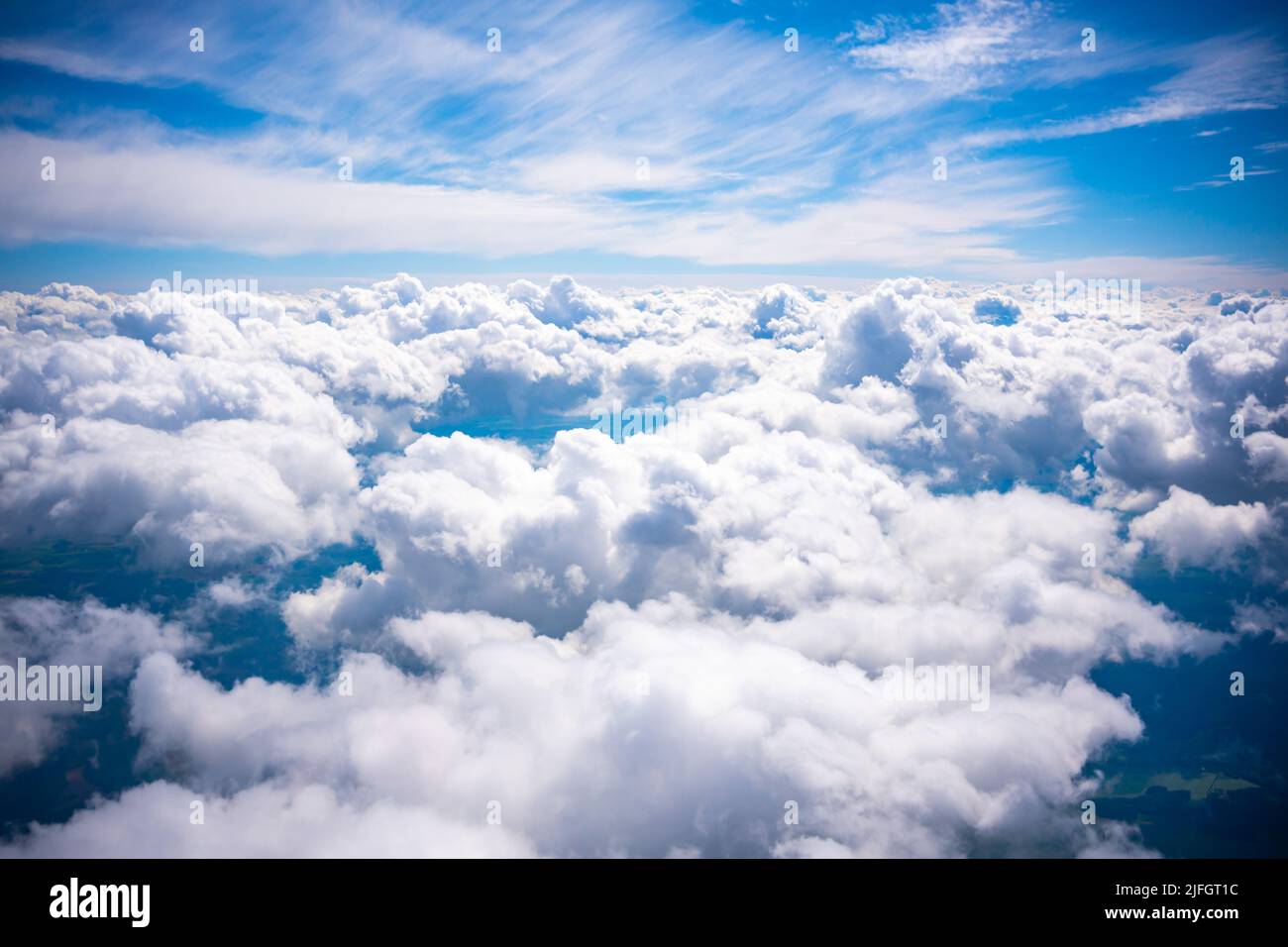 Aerial view scene of rural place which hiding under white fluffy clouds ...