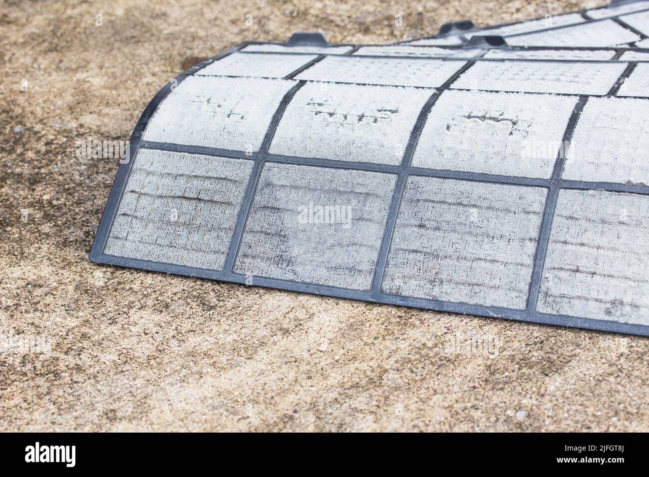 Dirty dust filters of air conditioner ready for cleaning on the ground ...