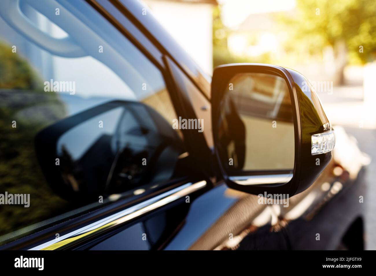 The rear view mirror on modern car on a black car. Rear view mirror car ...
