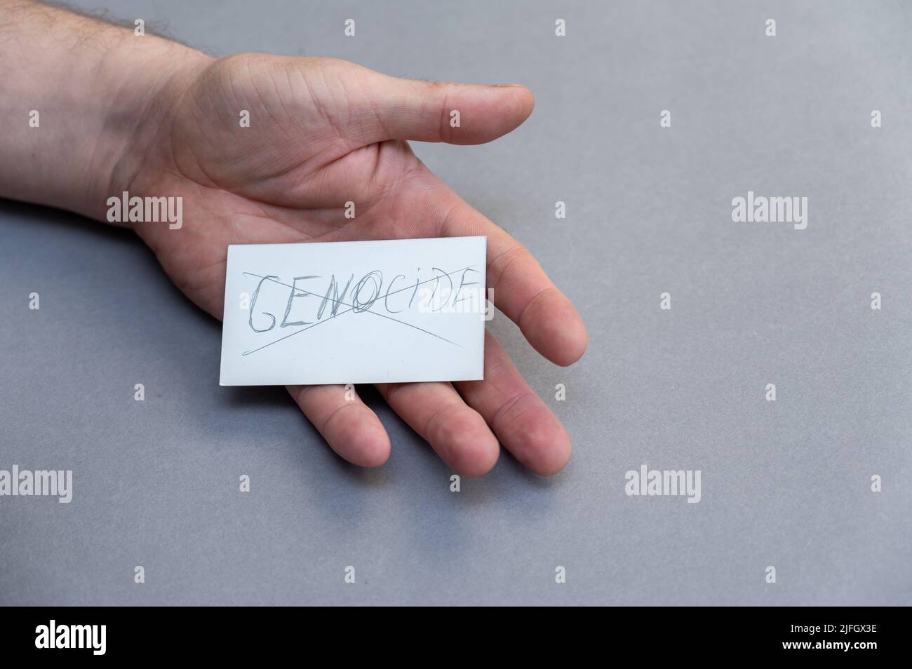 Crossed over with the word GENOCIDE. Handwritten gray lettering. Open ...