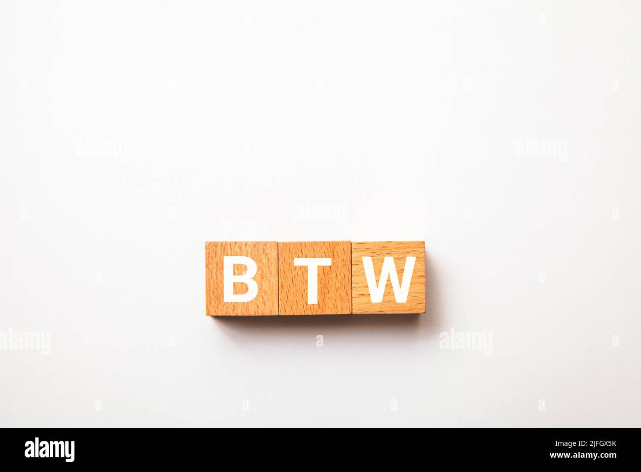 BTW characters. by the way. Written on three wooden blocks. White ...