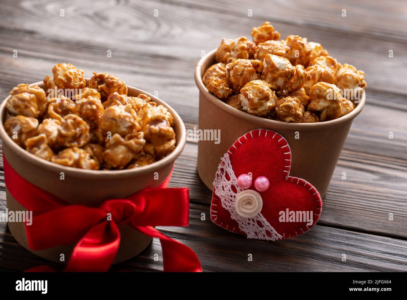 Carton buckets with caramelized popcorn and valentine decorations on ...