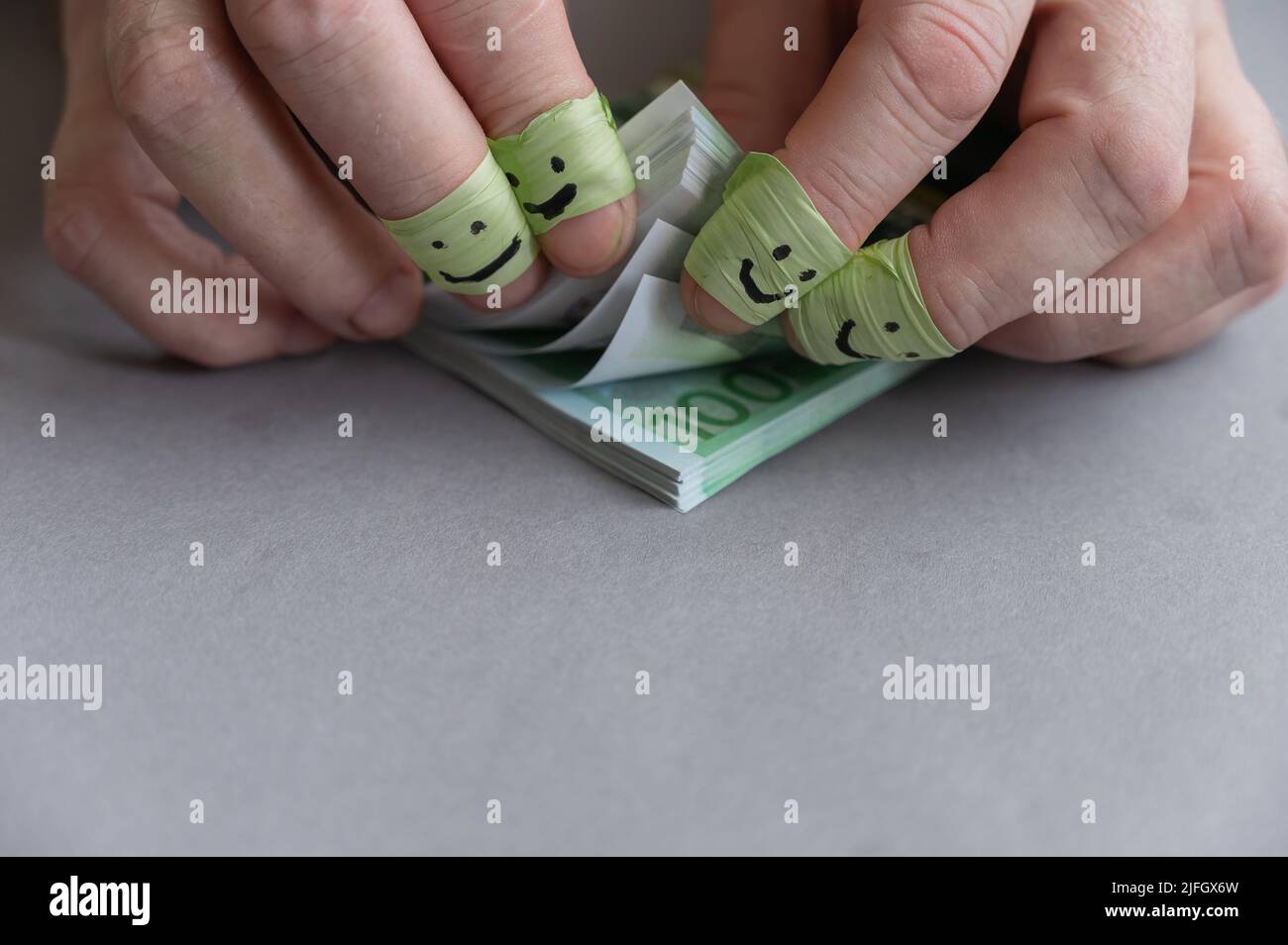 A man's fingers are counting the money. A wad of euro bills. The index ...