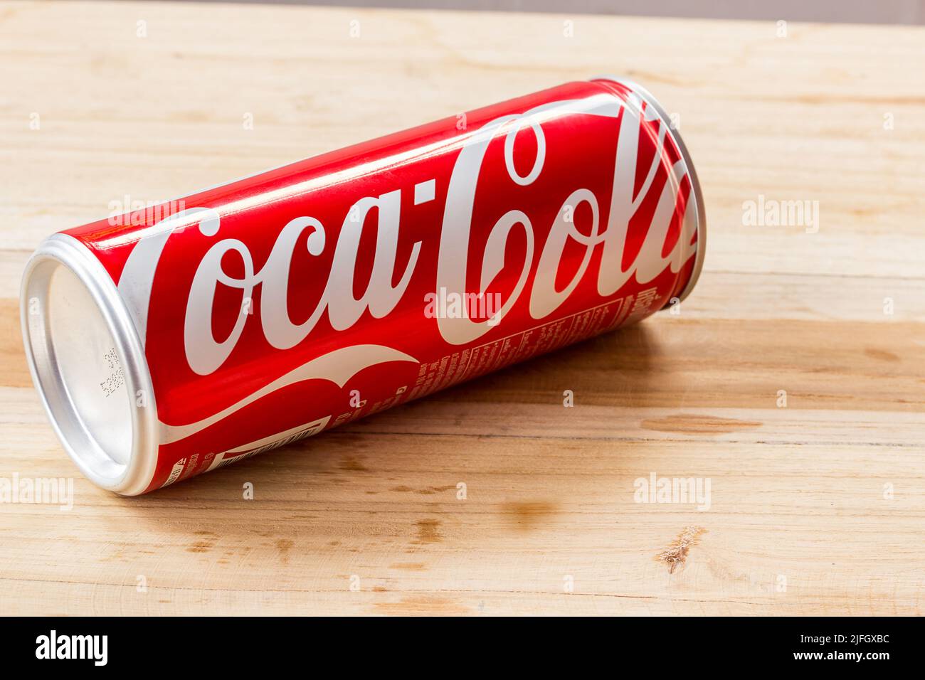 PHARE, THAILAND - MARCH 3, 2016. Coca Cola can on wooden table. Coca ...