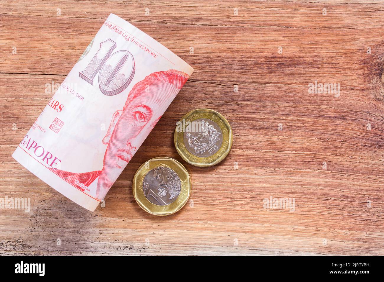 Singapore money on wooden table background, various of singapore dollar ...