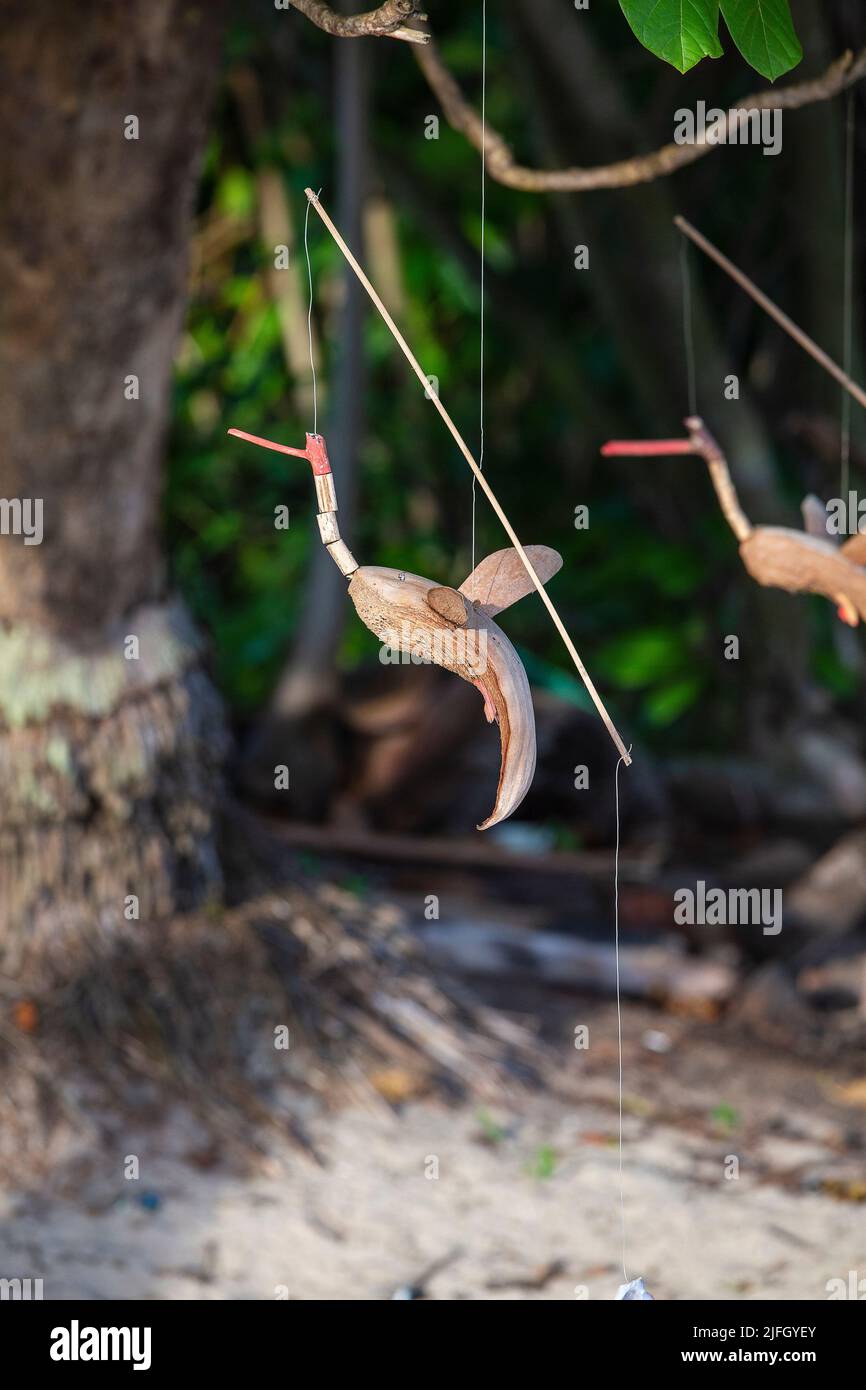 Toy bird made from coconut shells for sell for tourists on a tropical ...