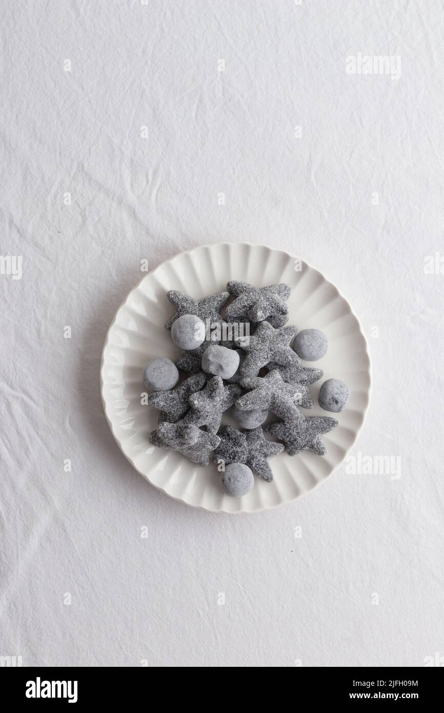 Salty liquorice salmiakki in Finnish in a white plate top view Stock ...