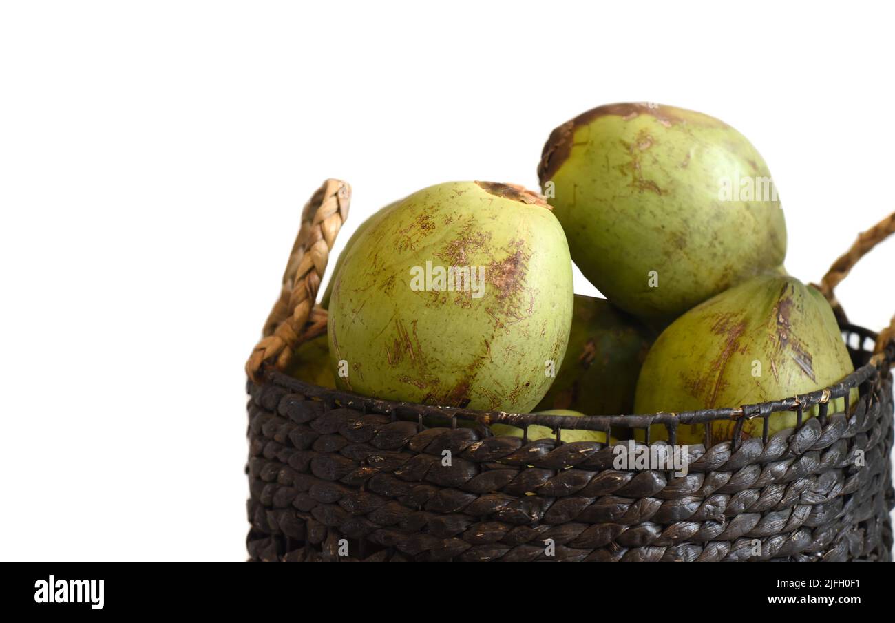 Fresh picked coconut in a basket on white background Stock Photo - Alamy