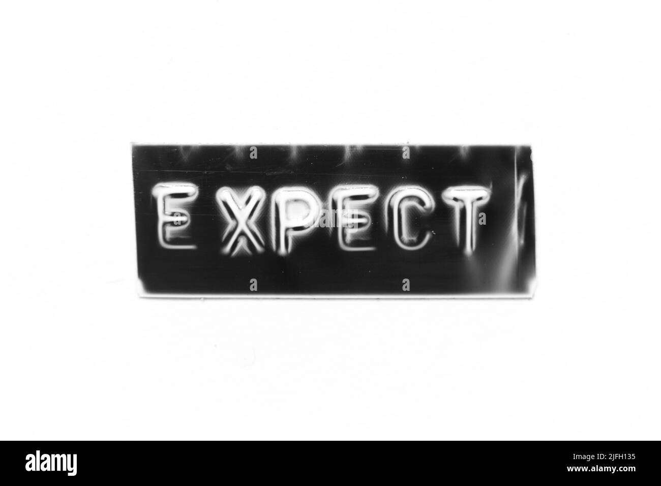 Black color banner that have embossed letter with word expect on white ...