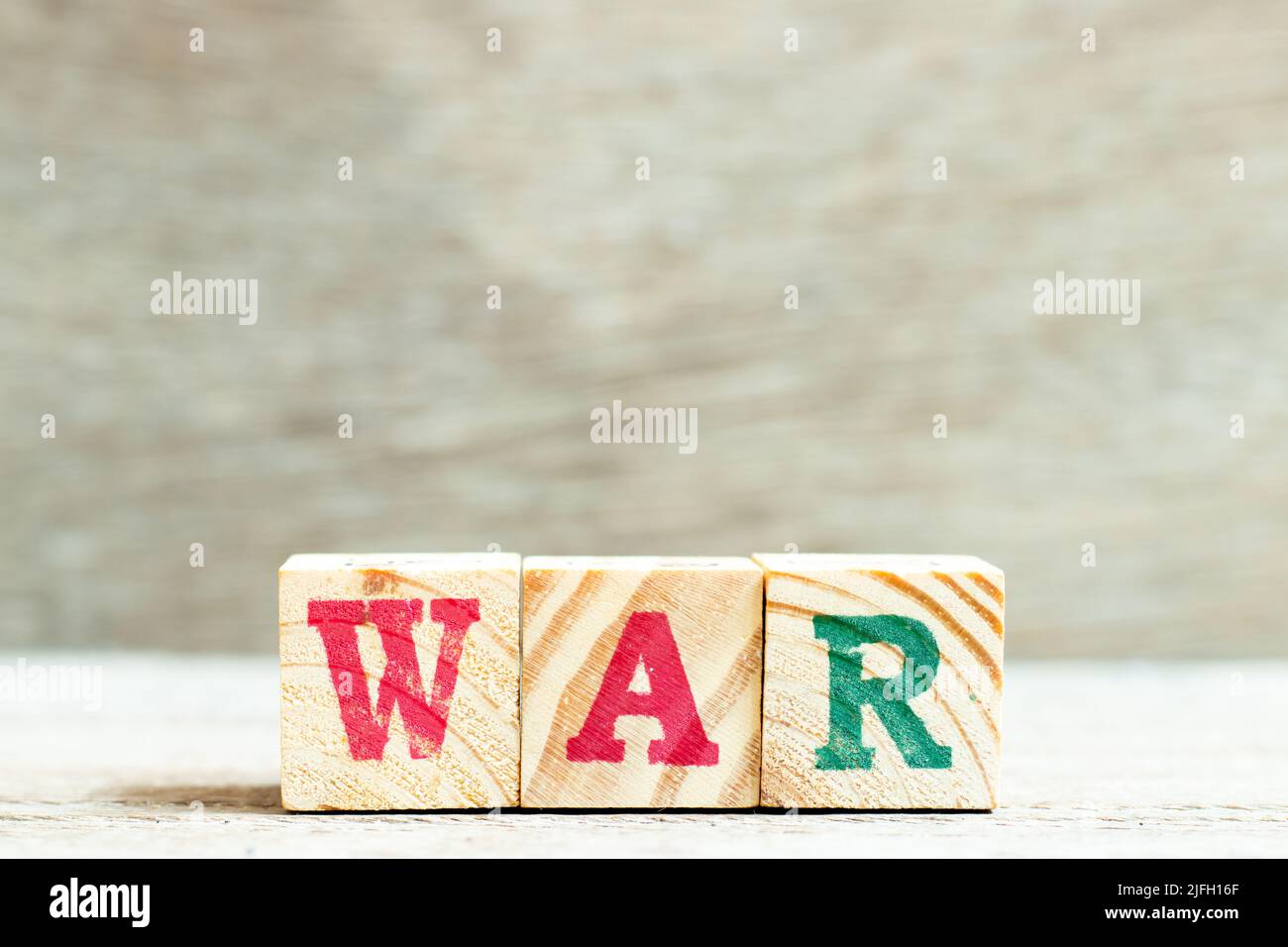 Alphabet letter block in word war on wood background Stock Photo - Alamy