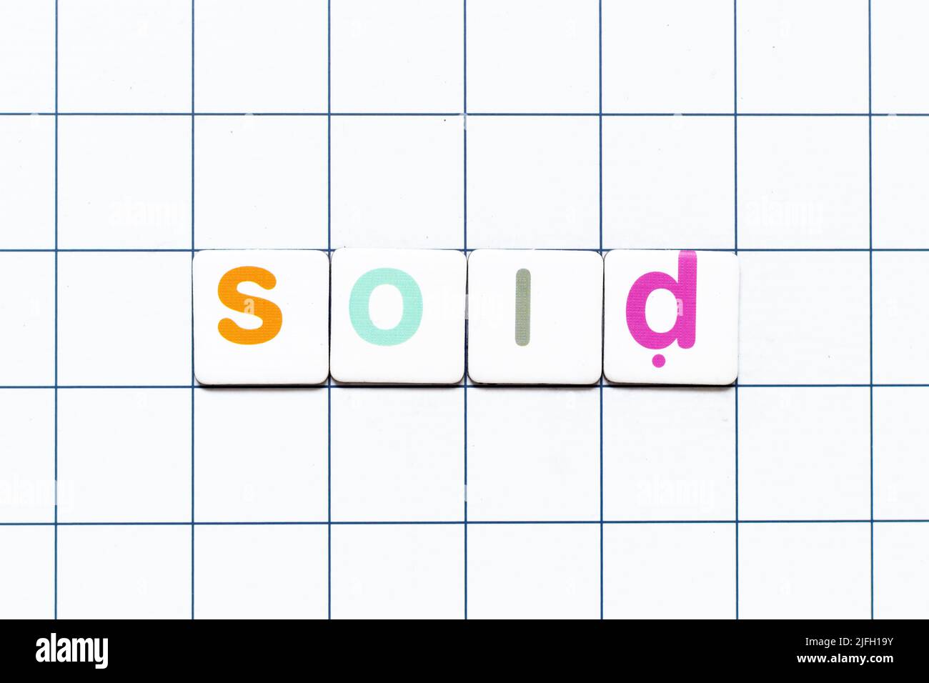 Colorful tile letter in word sold on white grid background Stock Photo ...
