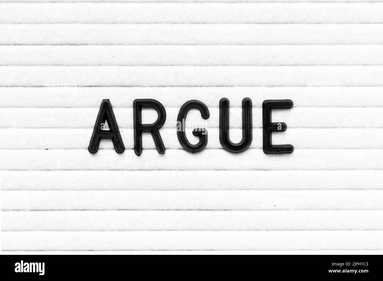 Black color letter in word argue on white felt board background Stock ...