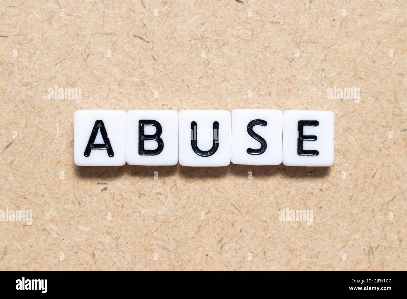 White tile alphabet letter with word abuse on wood background Stock ...