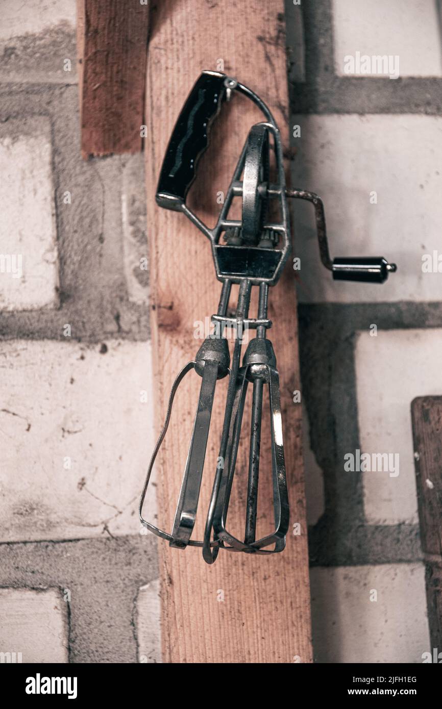 A vertical shot of hand mixer hanging from wall Stock Photo - Alamy