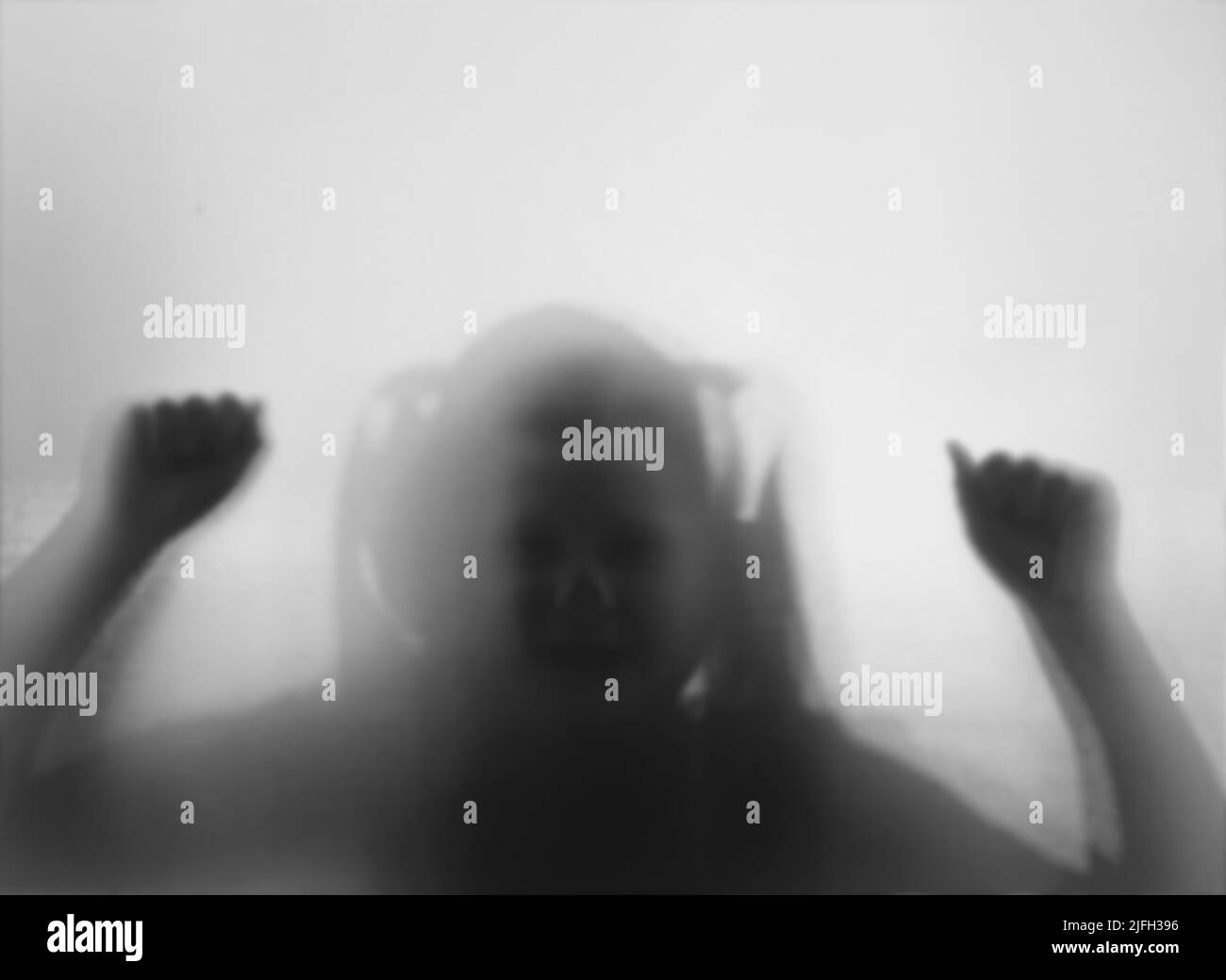 Horror ghost girl behind the matte glass in black and white. Halloween ...
