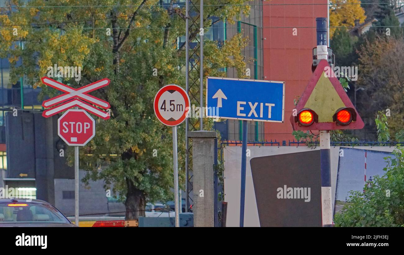 Rail road crossing signs stop warning lights exit Stock Photo - Alamy