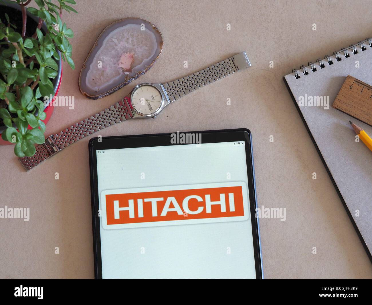In this photo illustration Hitachi Ltd. logo seen displayed on a tablet ...