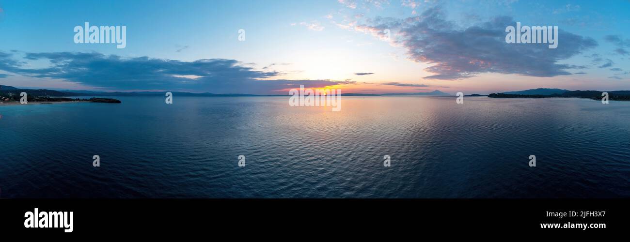 Sunrise over calm ocean aerial panoramic view. Dramatic sunset seascape ...