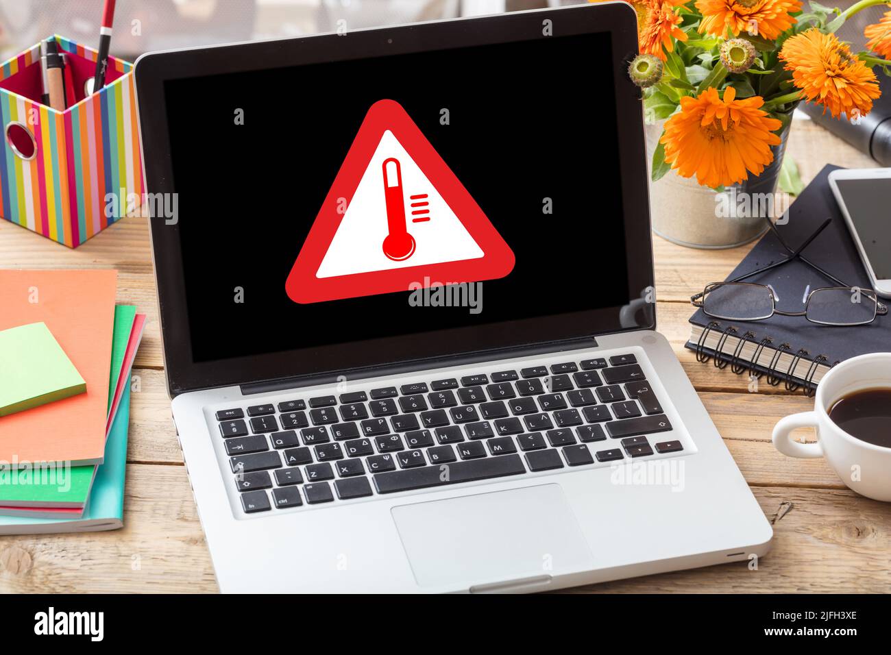 High temperature warning sign on a laptop screen. Computer overheating ...