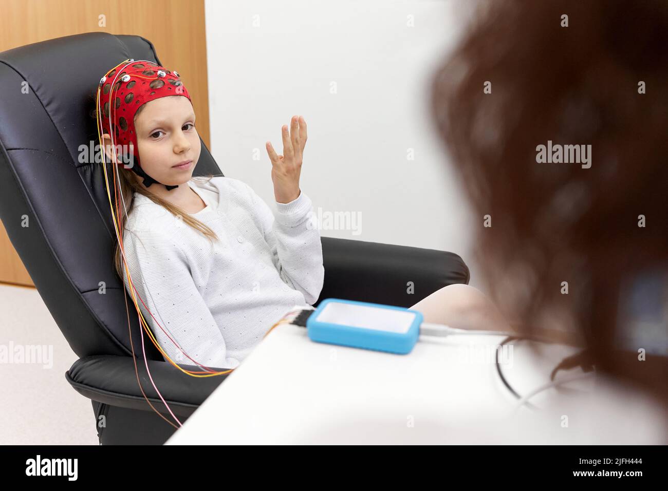 Patient raising the arm during a biofeedback session Stock Photo - Alamy