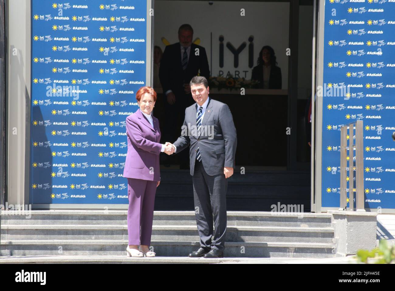 Ahmet Davuto?lu and Meral Ak?ener shake hands during the meeting. The 6 ...