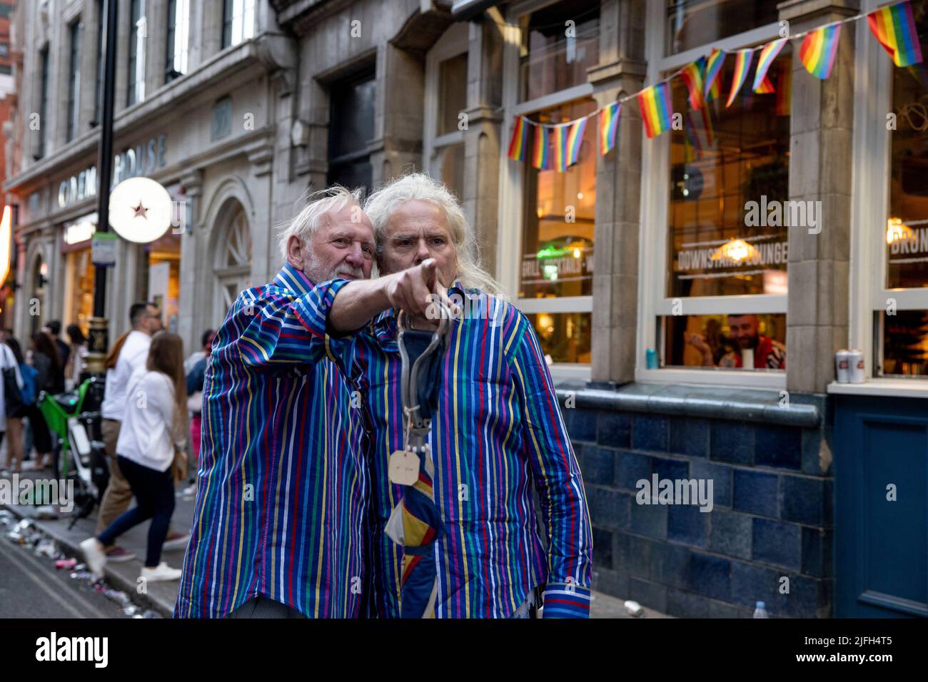 A gay couple is seen looking for direction in Soho in London. The 50th ...