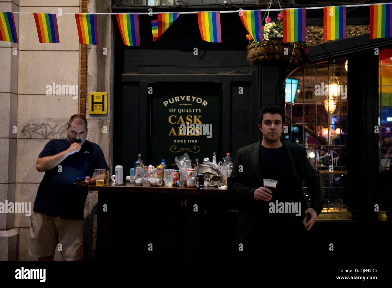 Men are seen drinking outside a pub in Soho. The 50th anniversary of ...