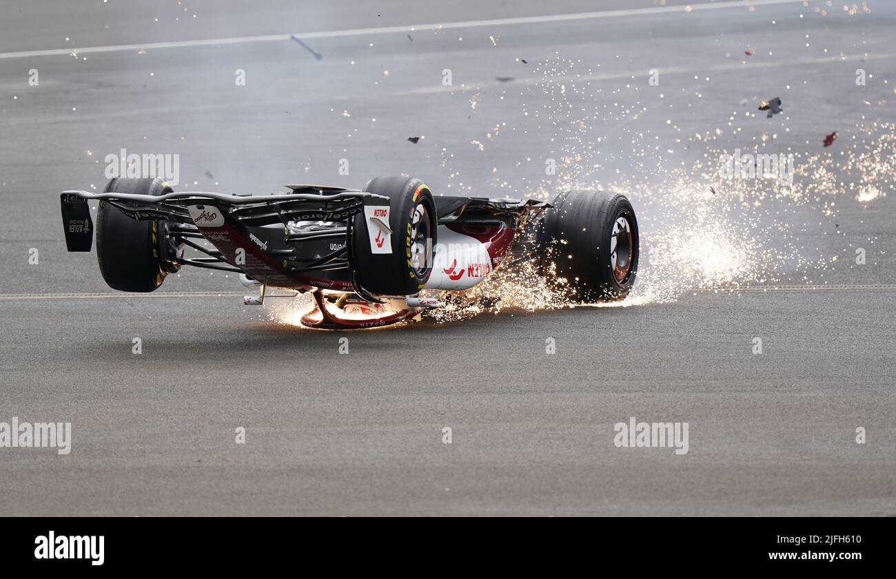 Alfa Romeo's Zhou Guanyu slides towards the barrier after a collision ...