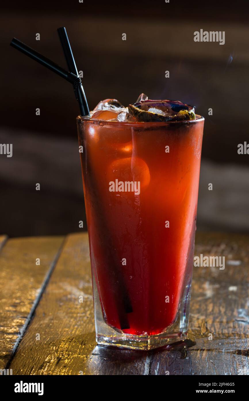 A mixed fruit drink with lots of ice and straws on top Stock Photo - Alamy