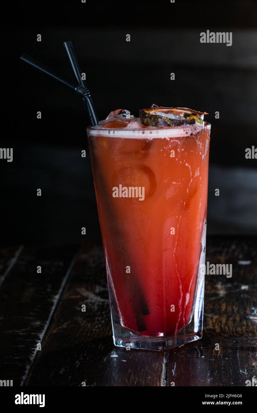 A mixed fruit drink with lots of ice and straws on top Stock Photo - Alamy